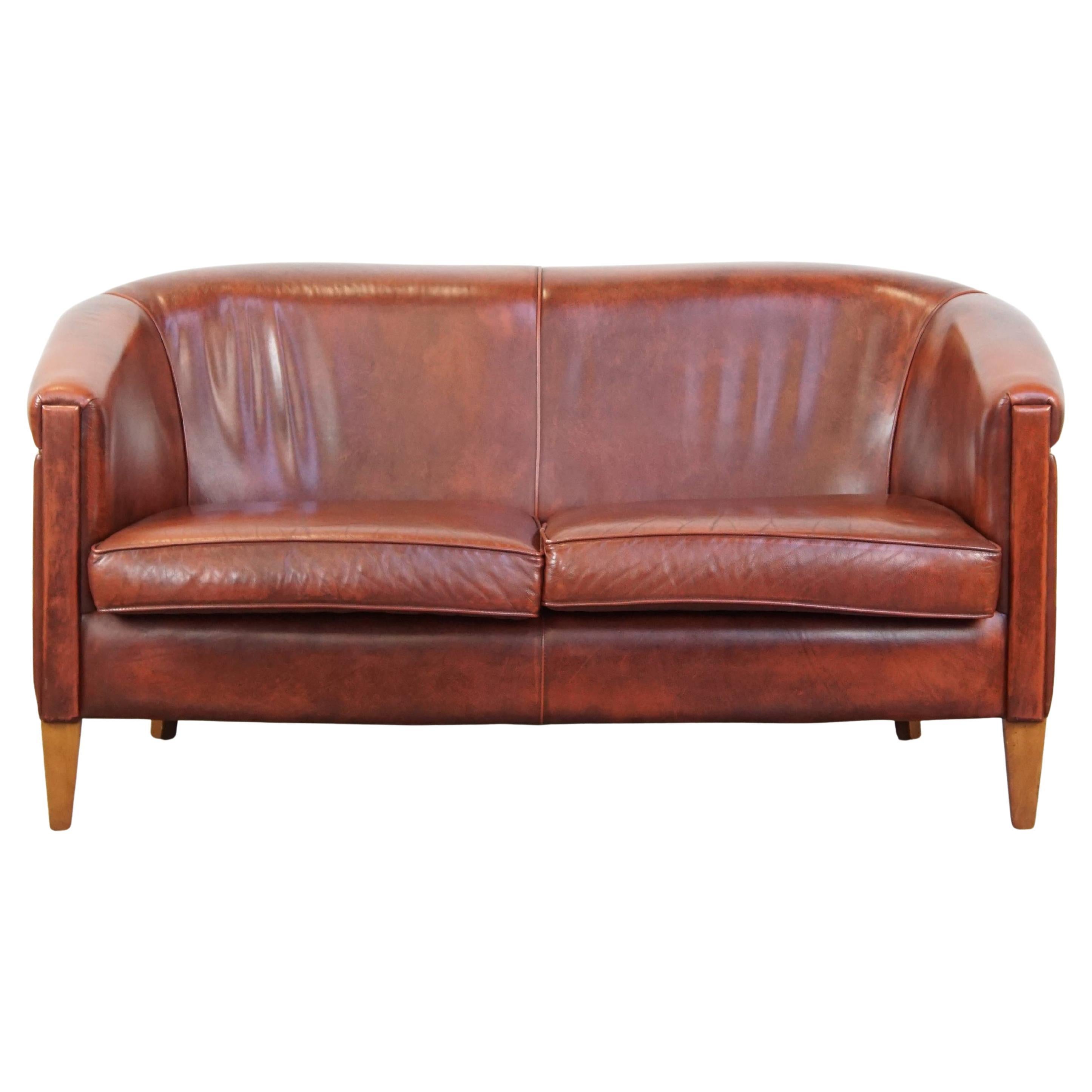 Sleek, luxurious oxblood red cow leather 2-seater sofa in good ...
