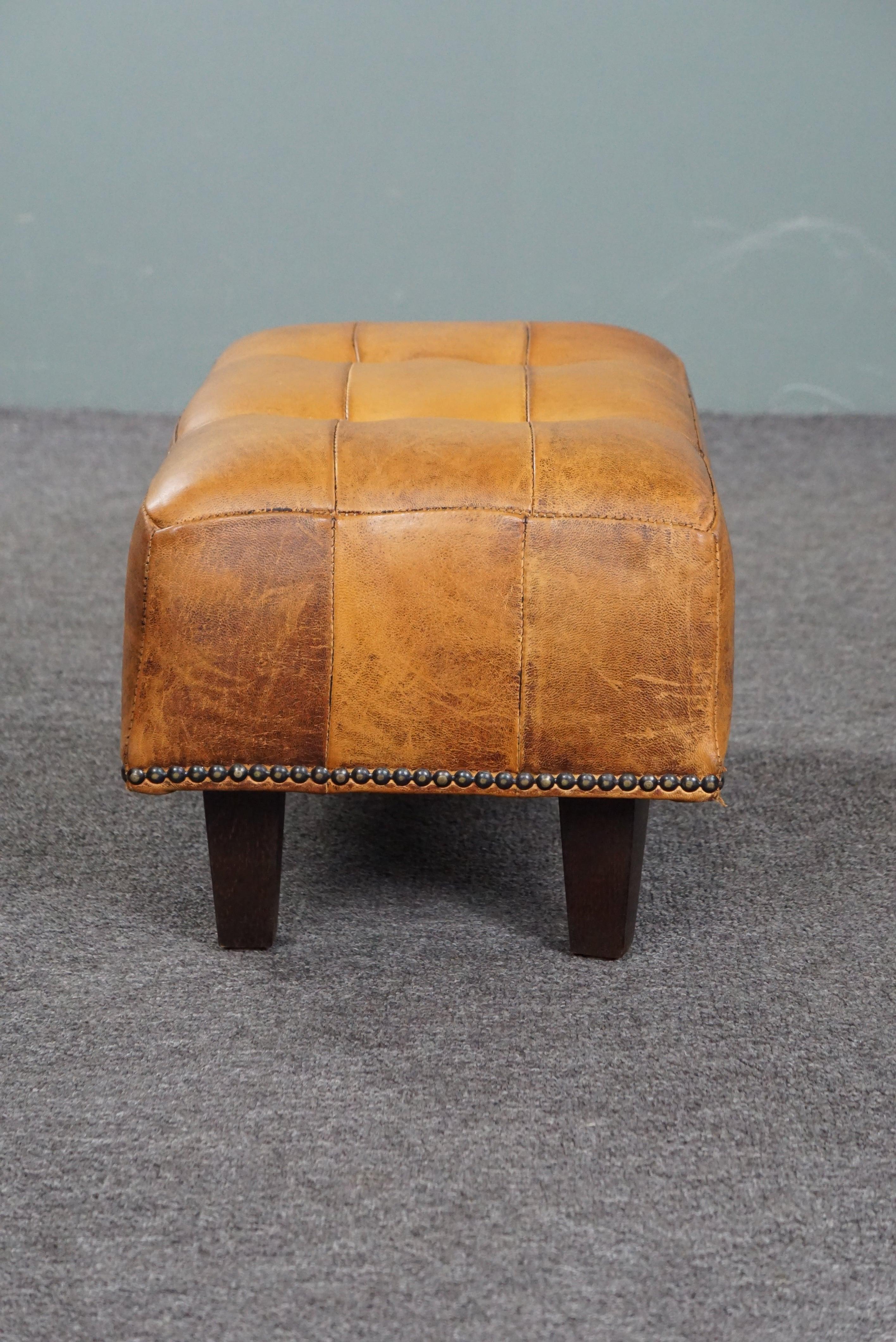 Subtle sheep leather ottoman with beautiful details For Sale at 1stDibs