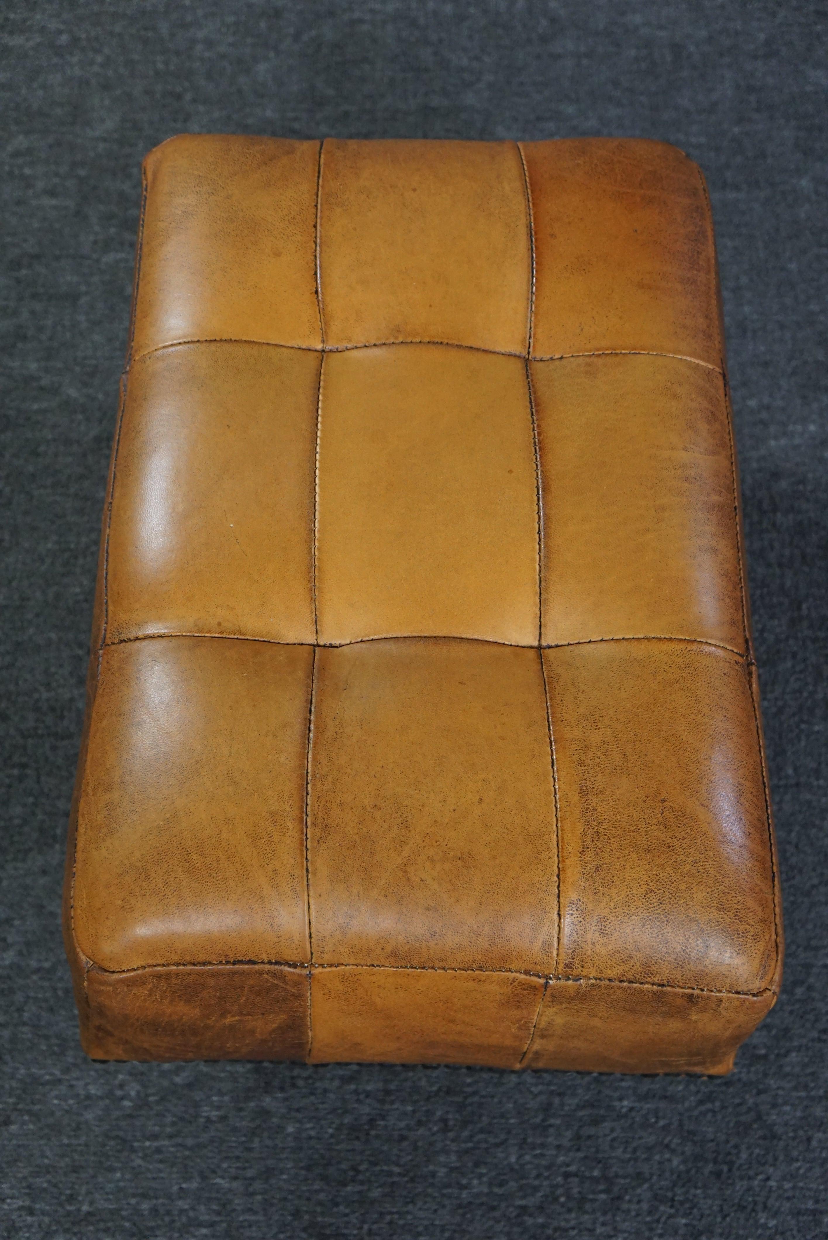 Subtle sheep leather ottoman with beautiful details For Sale at 1stDibs