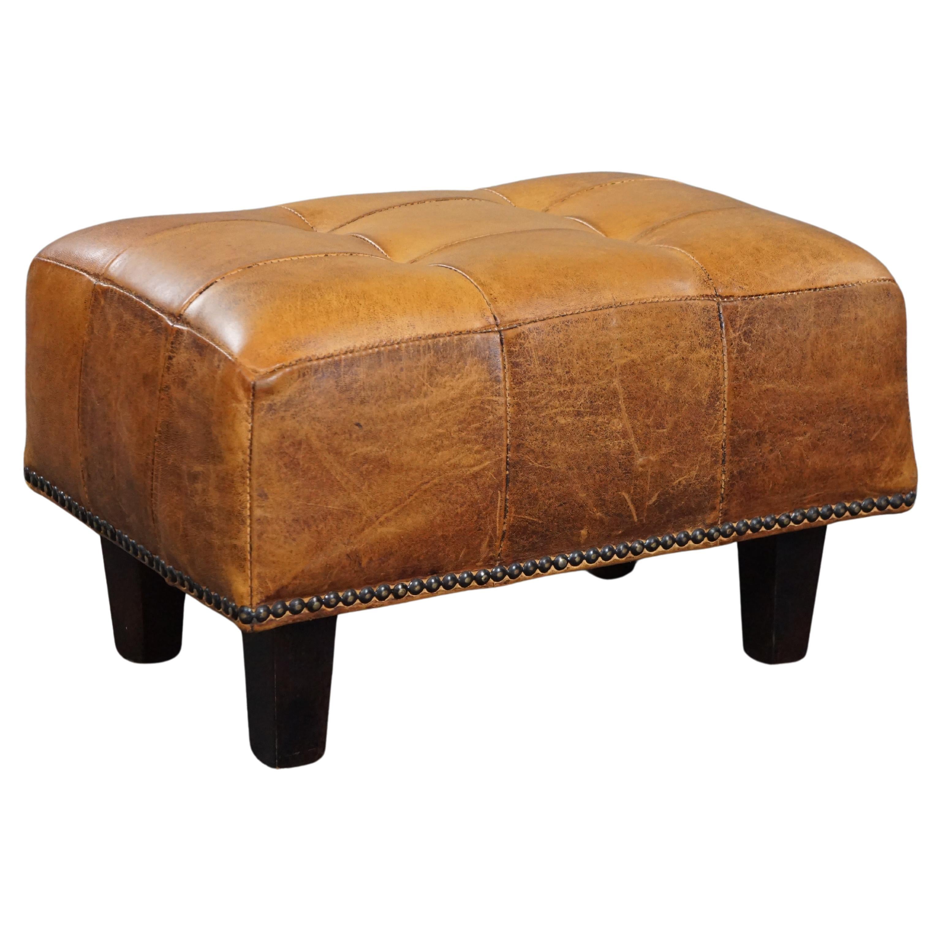 Subtle sheep leather ottoman with beautiful details For Sale at 1stDibs
