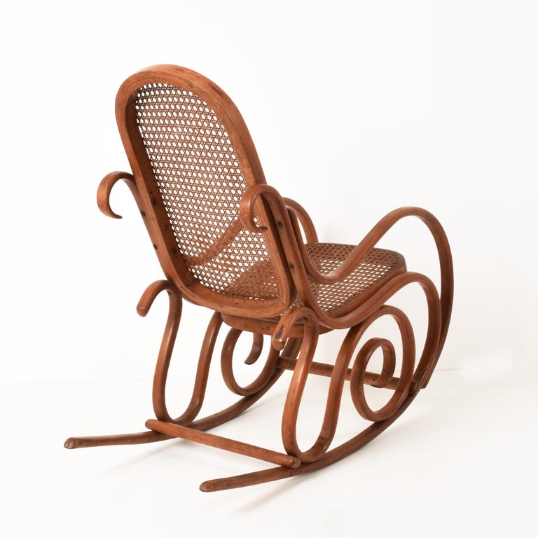 Thonet. A Vintage Bentwood Child's Rocking Chair with Cane Back and ...