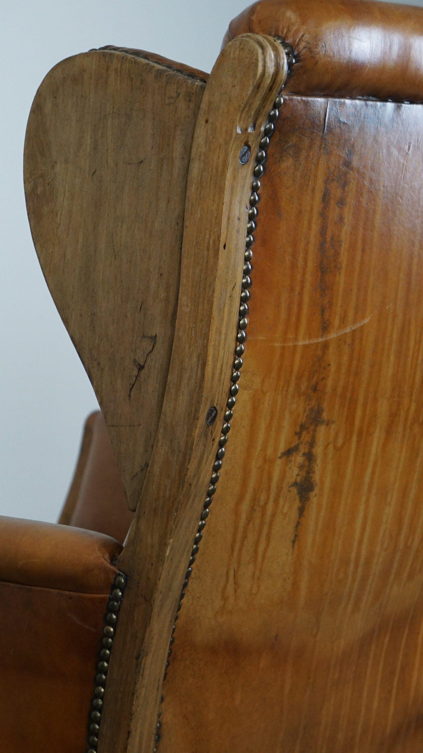 Unique leather wingback armchair with wooden details For Sale at 1stDibs