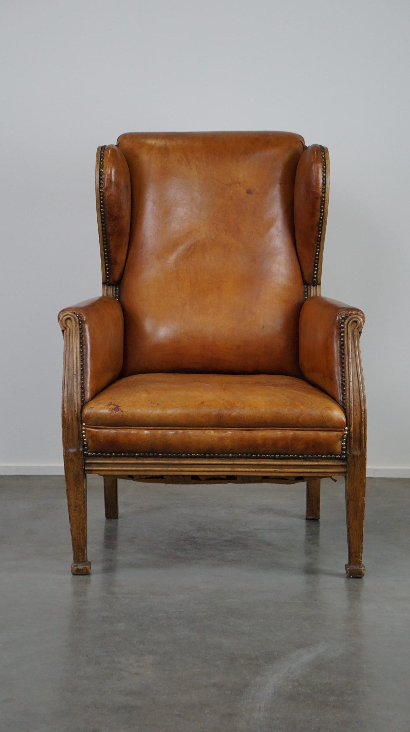 Unique leather wingback armchair with wooden details For Sale at 1stDibs