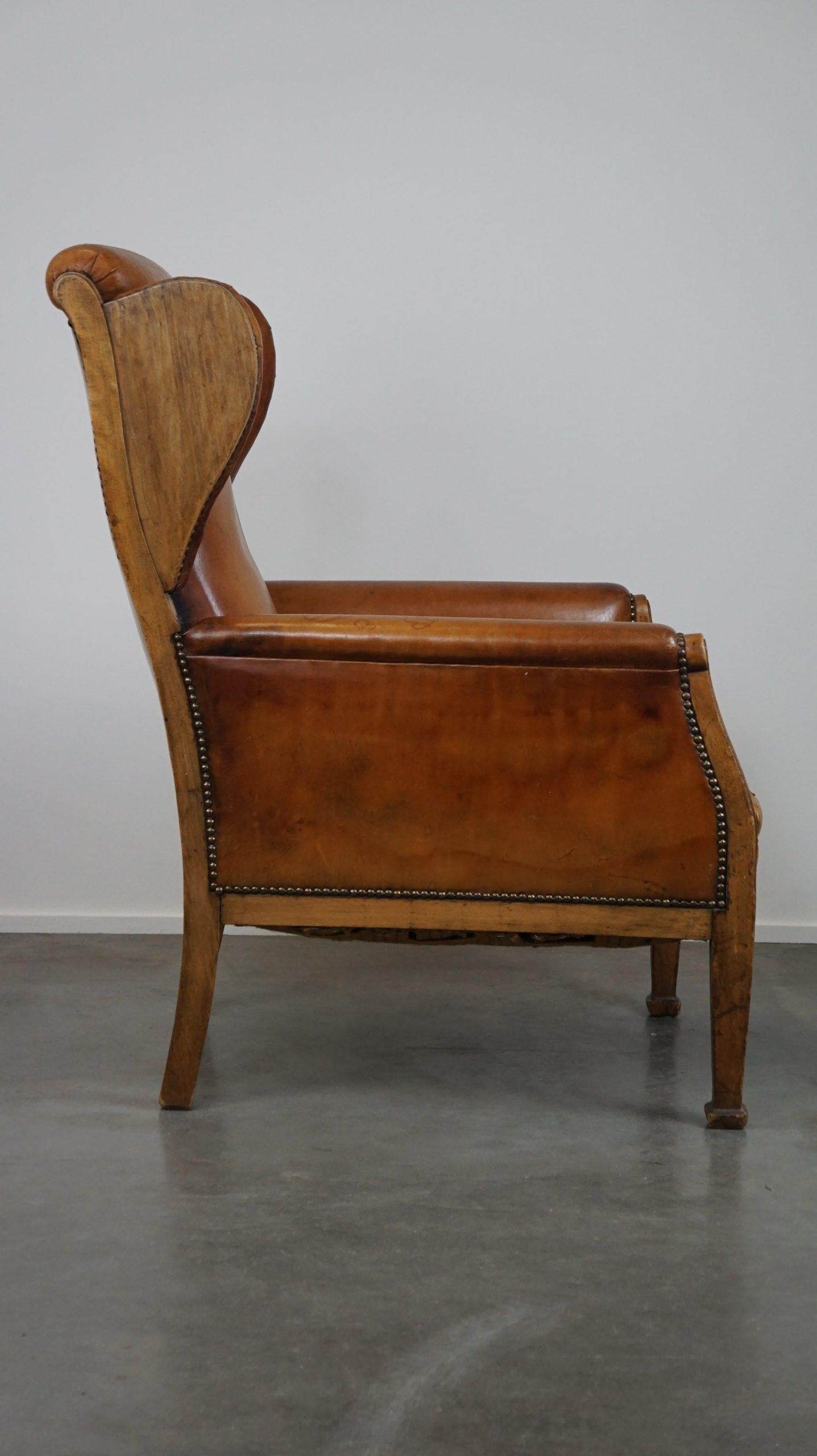 Unique leather wingback armchair with wooden details For Sale at 1stDibs