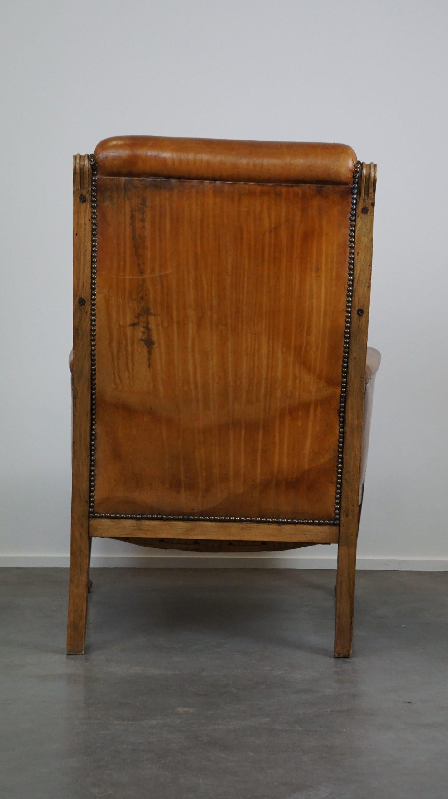 Unique leather wingback armchair with wooden details For Sale at 1stDibs
