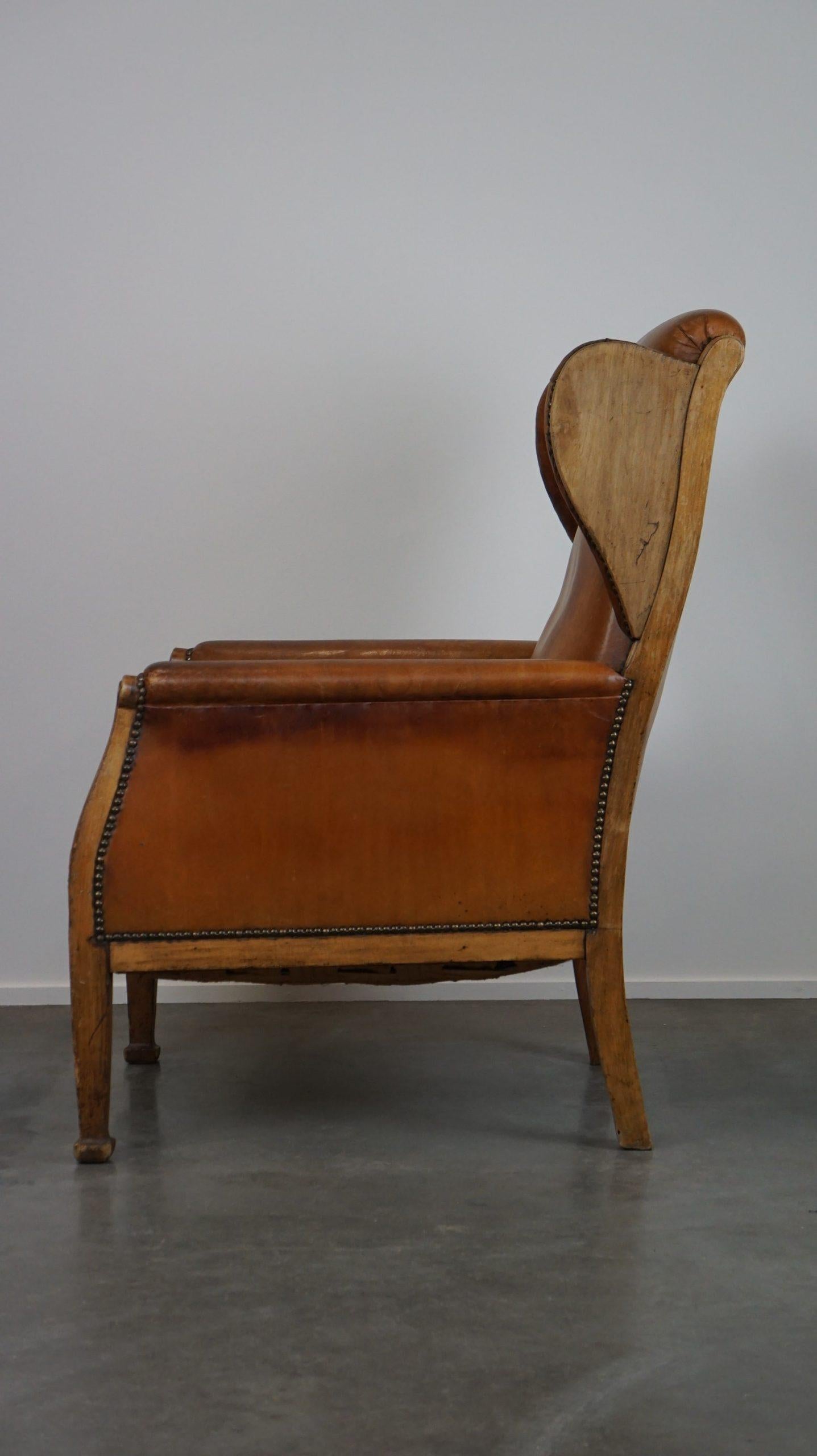 Unique leather wingback armchair with wooden details For Sale at 1stDibs