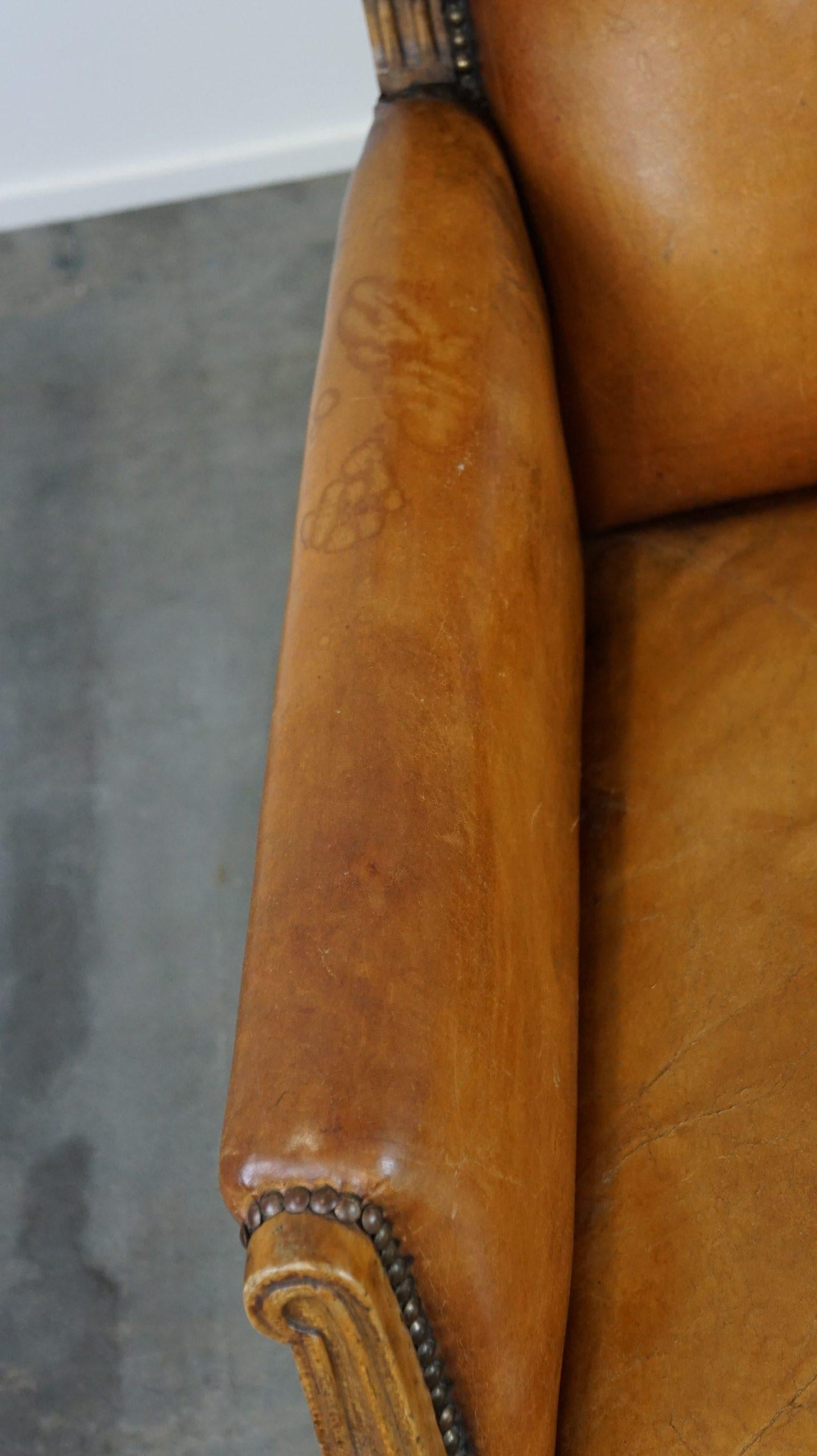 Unique leather wingback armchair with wooden details For Sale at 1stDibs