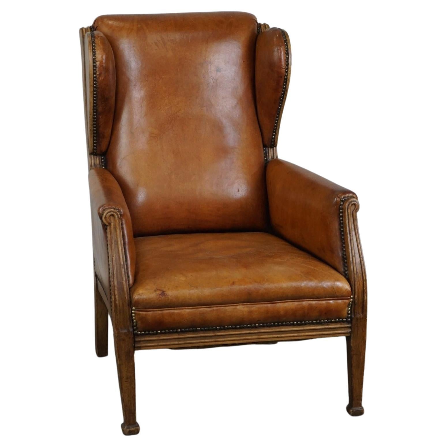 Unique leather wingback armchair with wooden details For Sale at 1stDibs