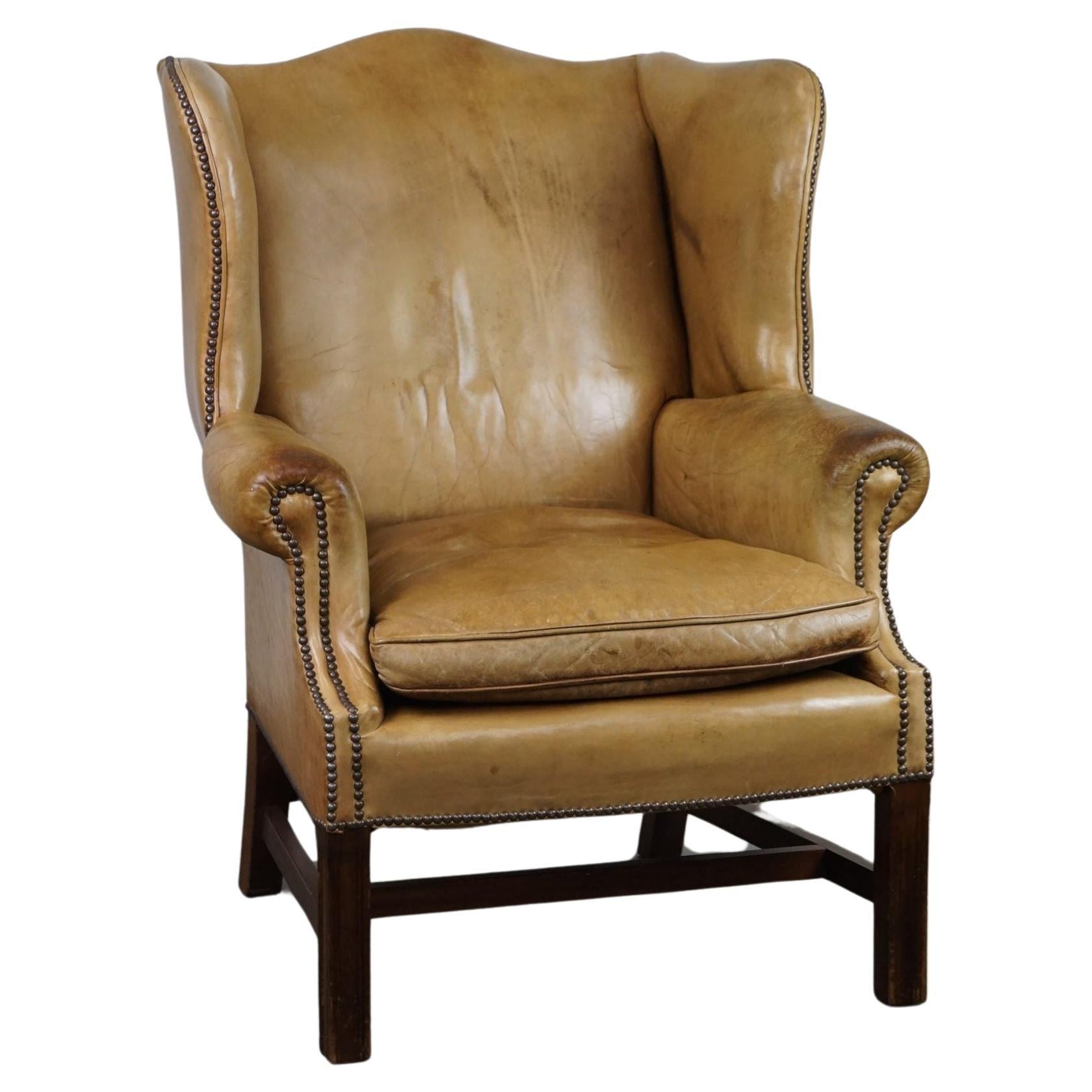 Unique leather wingback armchair with wooden details For Sale at 1stDibs