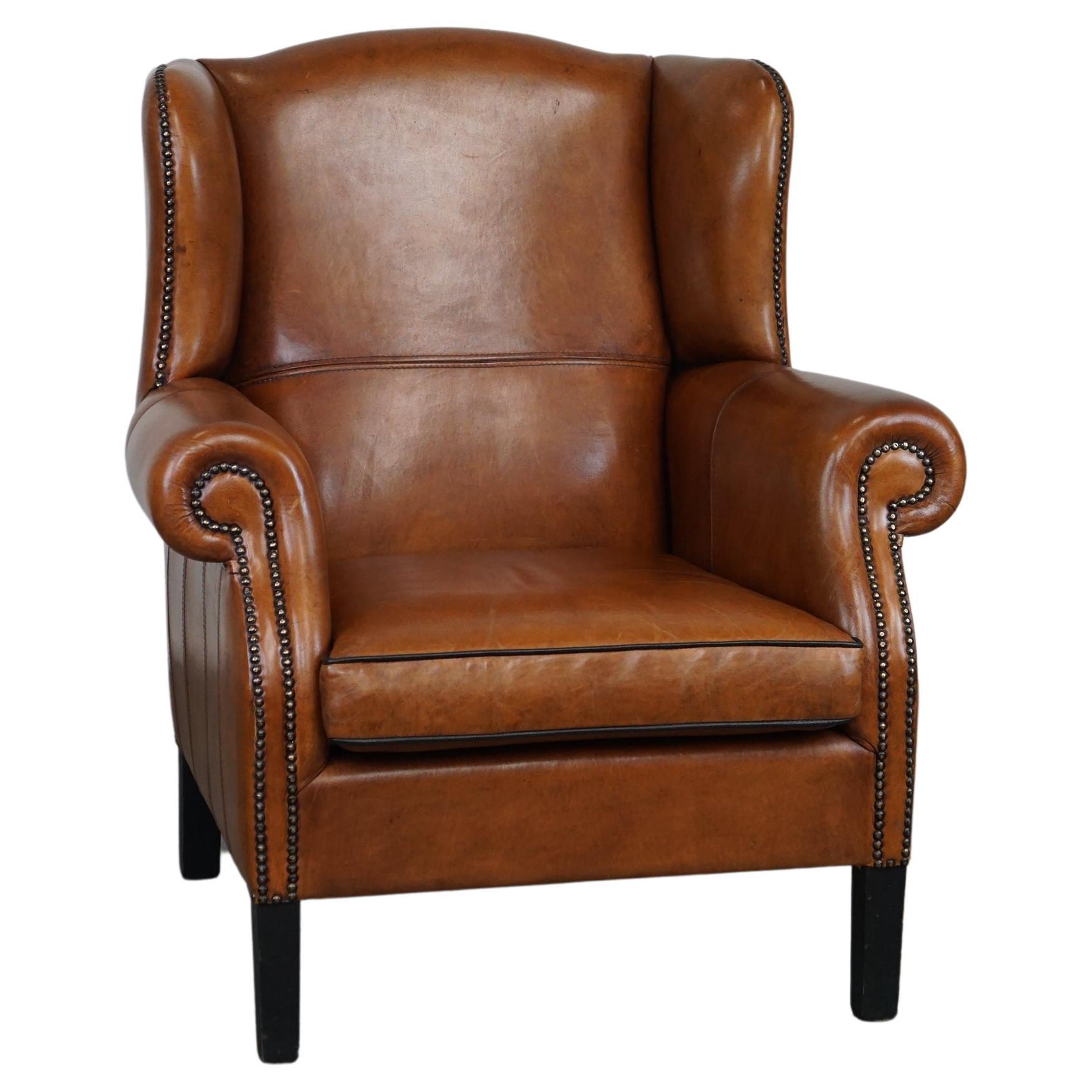 Unique leather wingback armchair with wooden details For Sale at 1stDibs