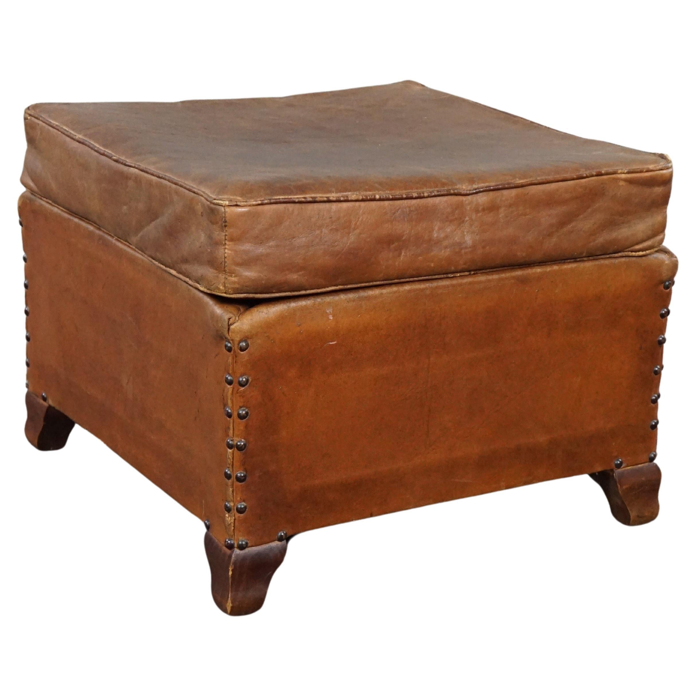Very characteristic old cowhide ottoman For Sale at 1stDibs