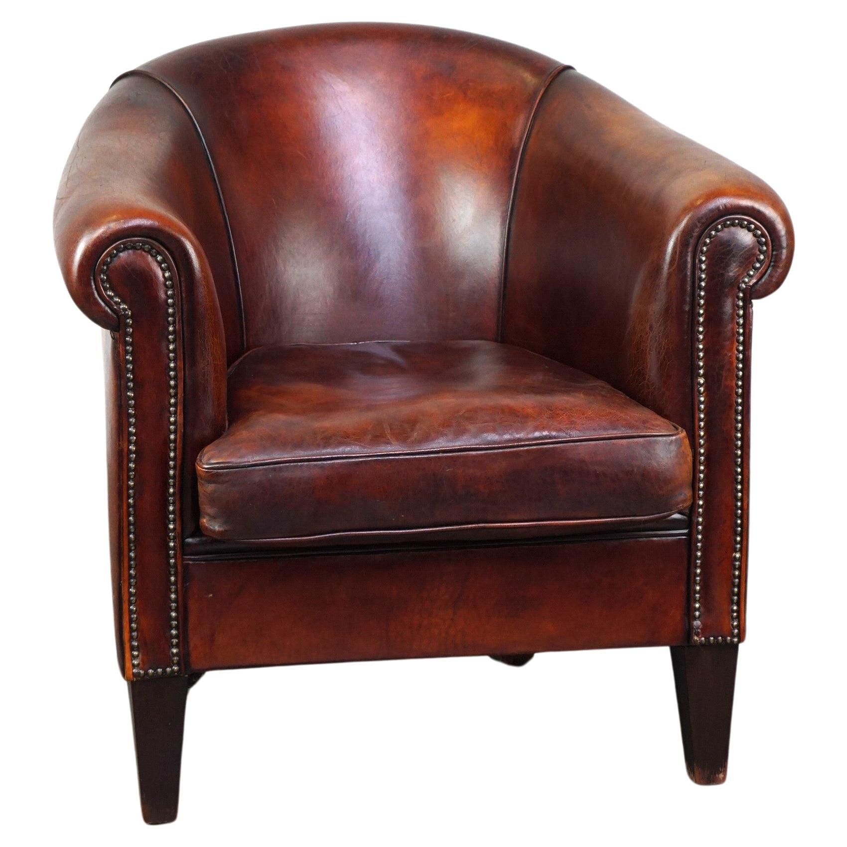 Very luxurious dark brown sheepskin club chair with a more than ...