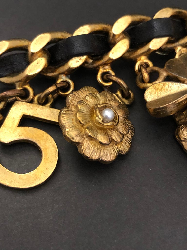 Vintage CHANEL Gold Toned Leather Chain Perfume Lion Camellia Clover Brooch For Sale at 1stDibs