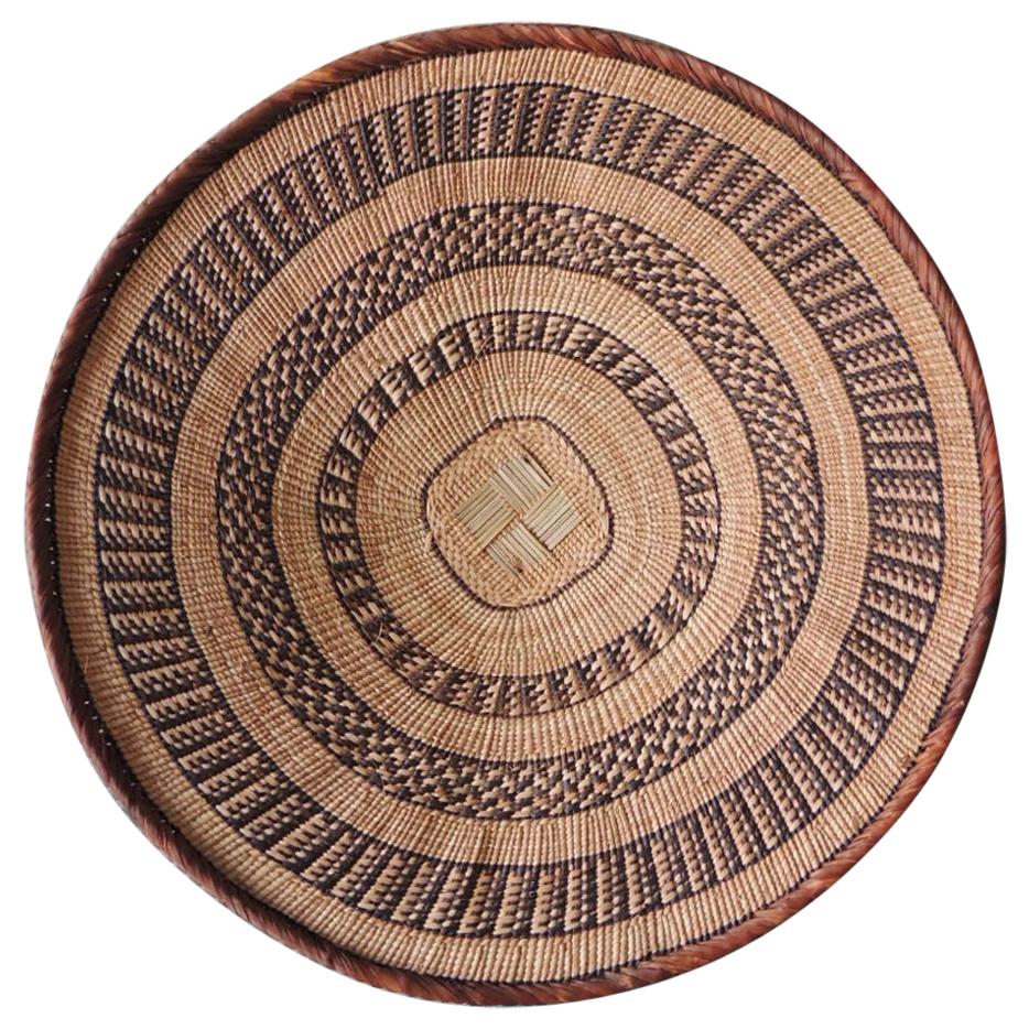 Vintage Tribal Tan and Brown Woven Round African Basket at 1stDibs