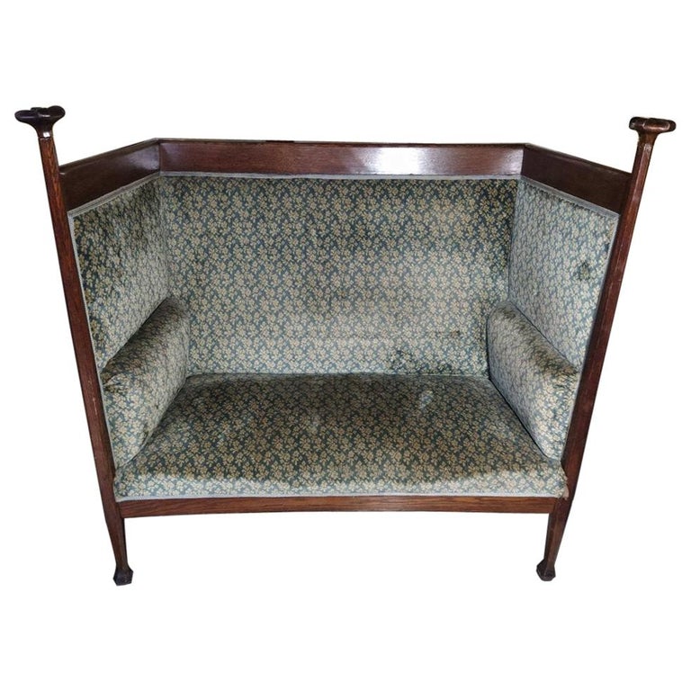 Walter Cave, an Arts and Crafts Oak Settee with Voysey Style Uprights ...