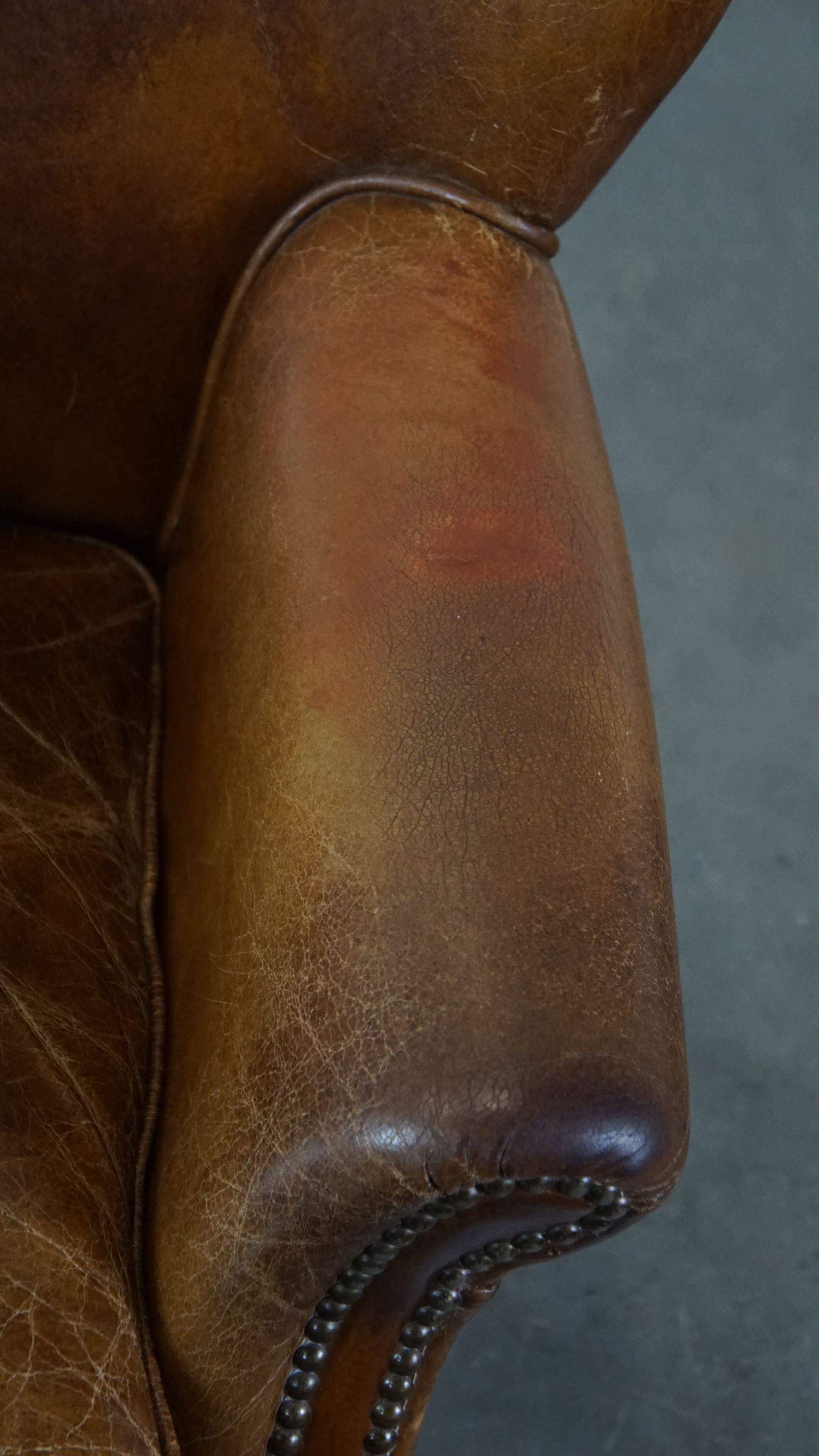 Warm cognac-colored subtle armchair For Sale at 1stDibs