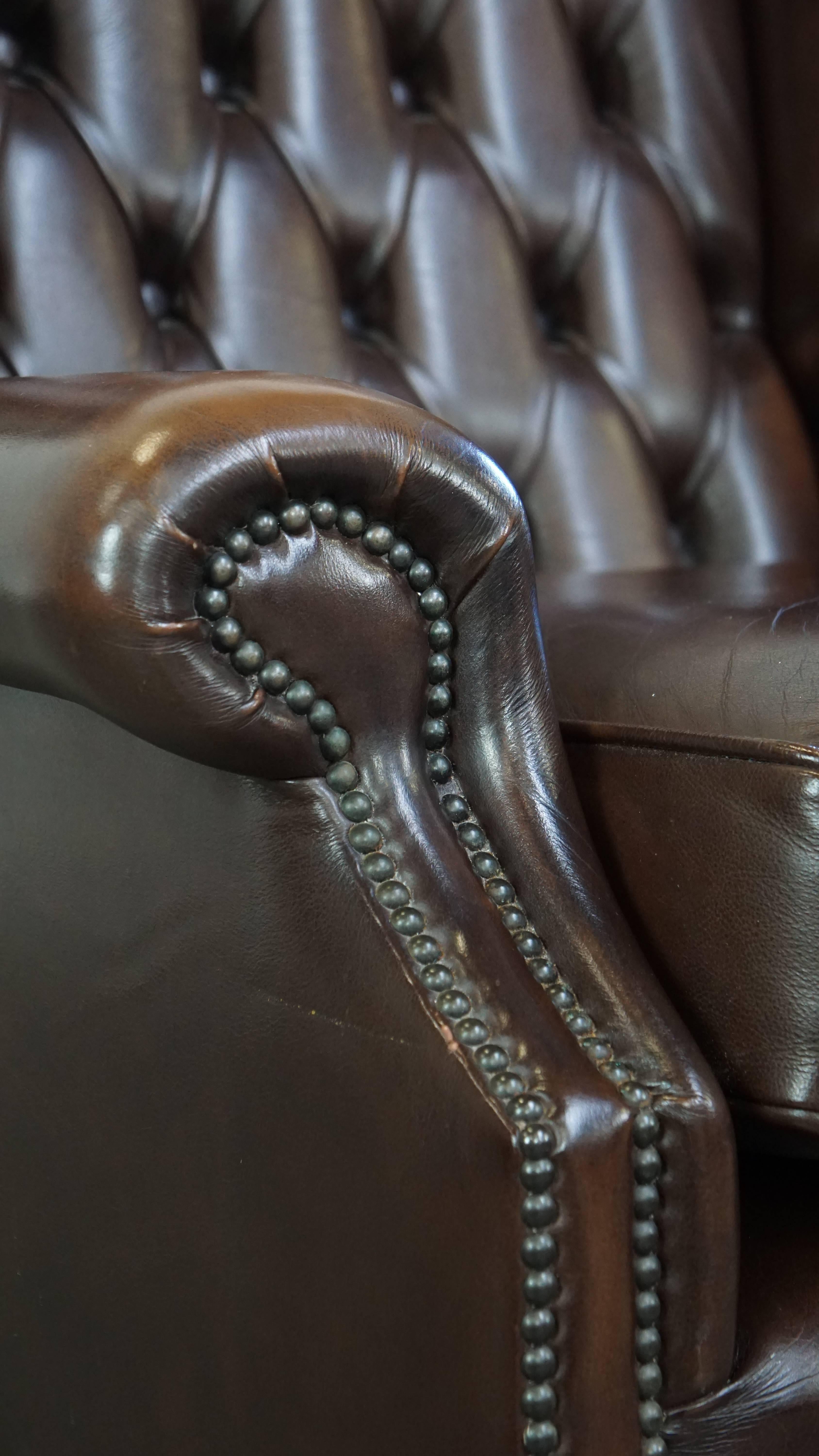Well-maintained cowhide leather chesterfield wingback chair with ...