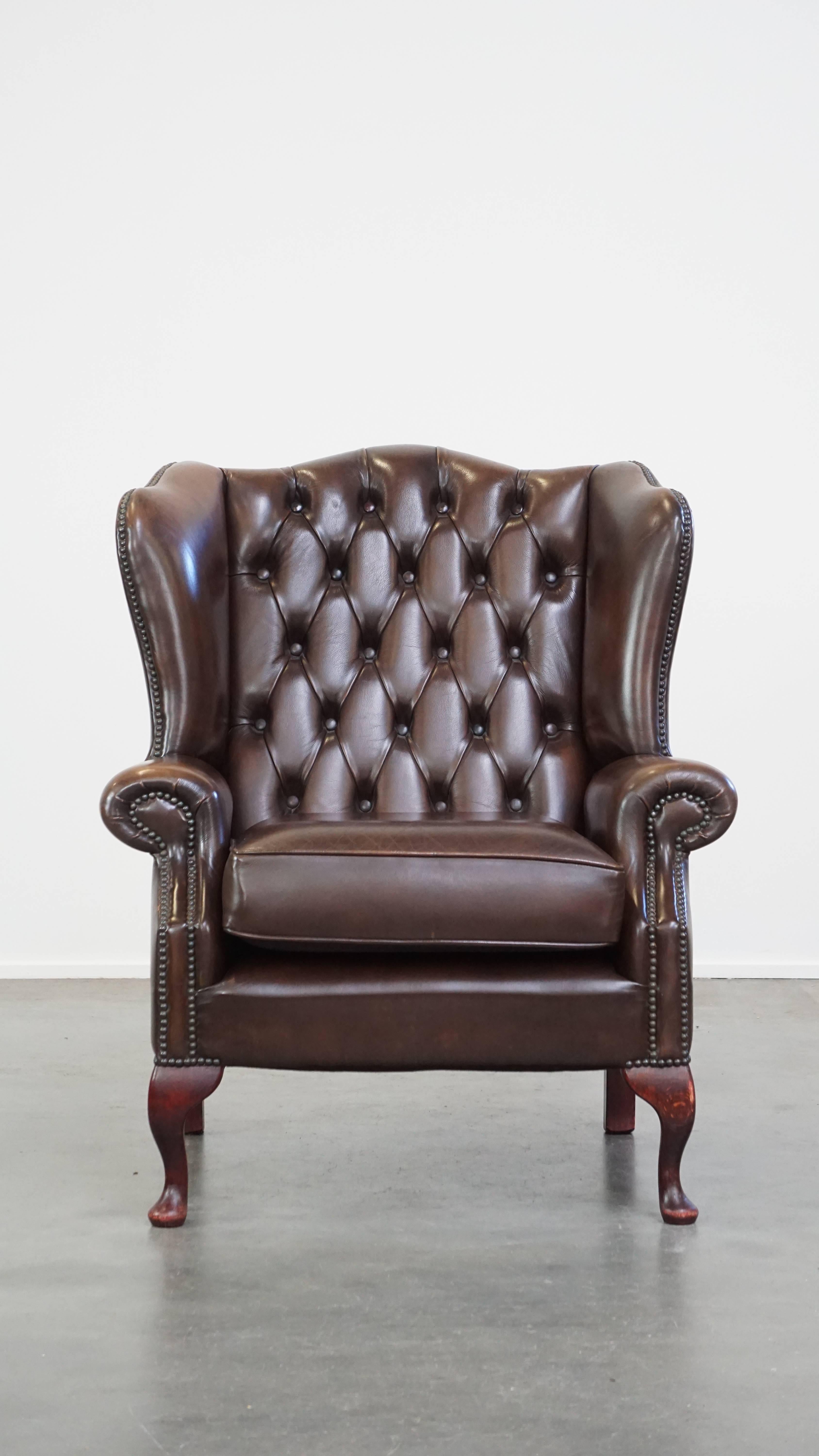 Well-maintained cowhide leather chesterfield wingback chair with ...