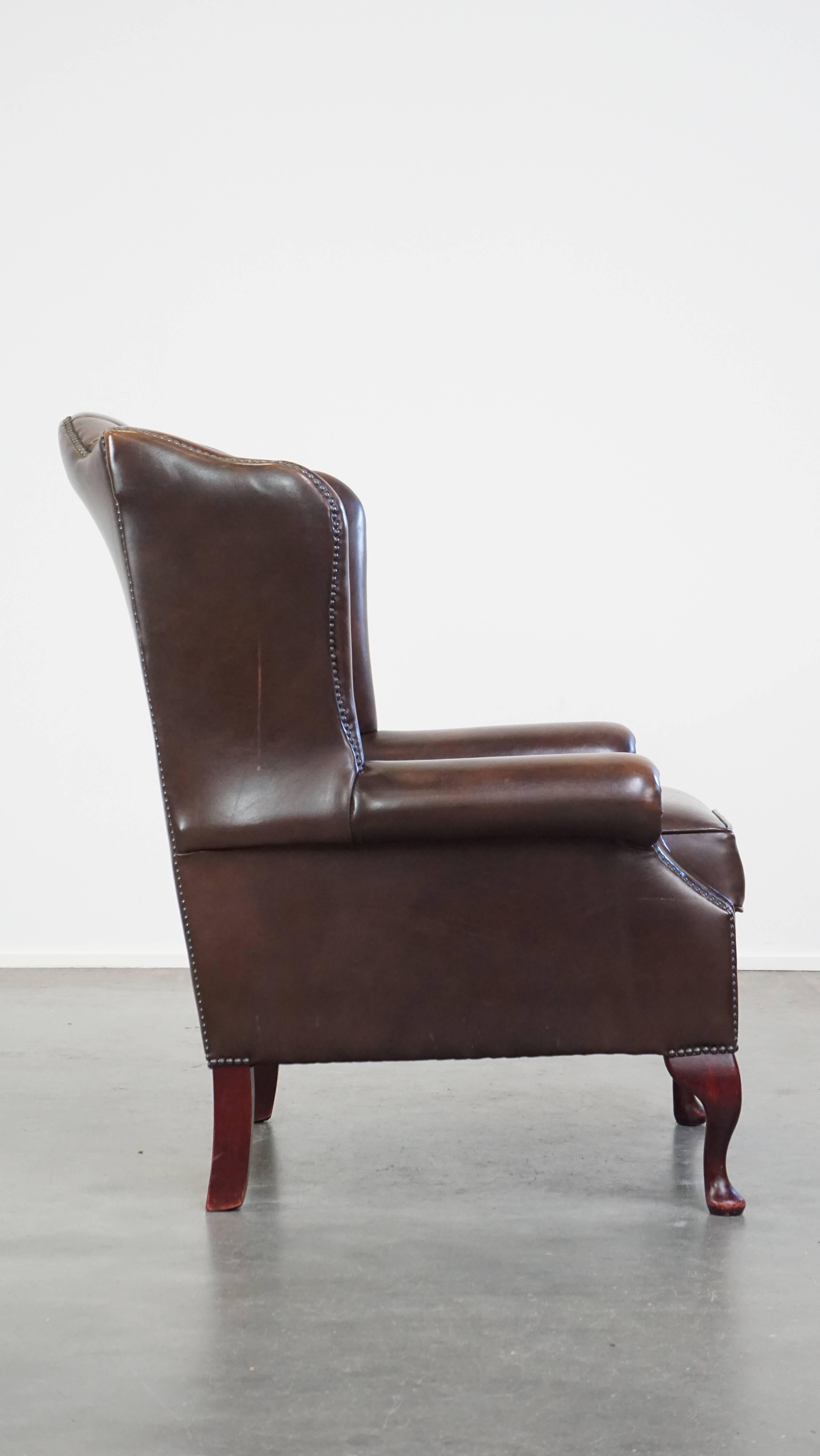 Well-maintained cowhide leather chesterfield wingback chair with ...