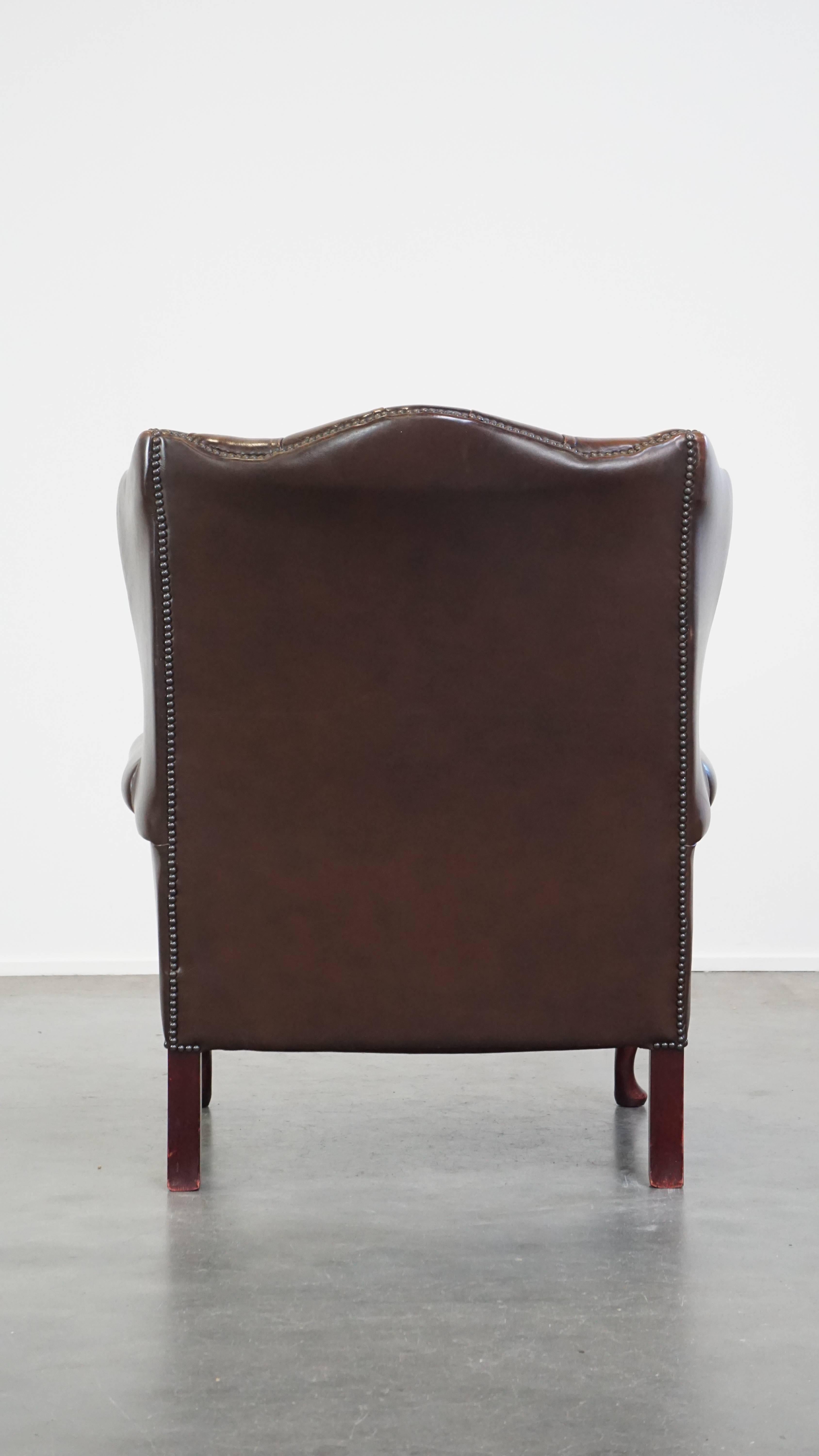 Well-maintained cowhide leather chesterfield wingback chair with ...