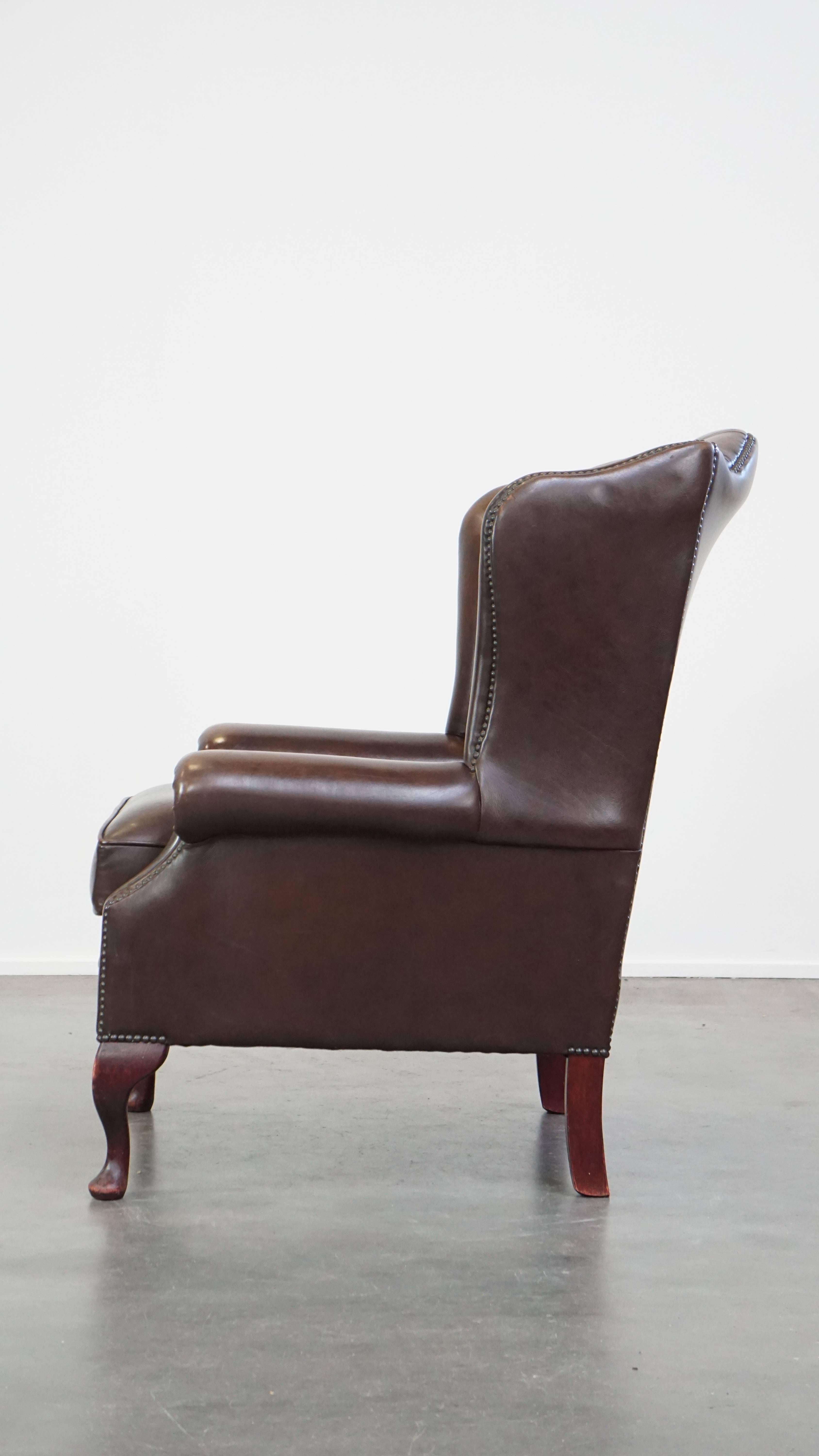 Well-maintained cowhide leather chesterfield wingback chair with ...