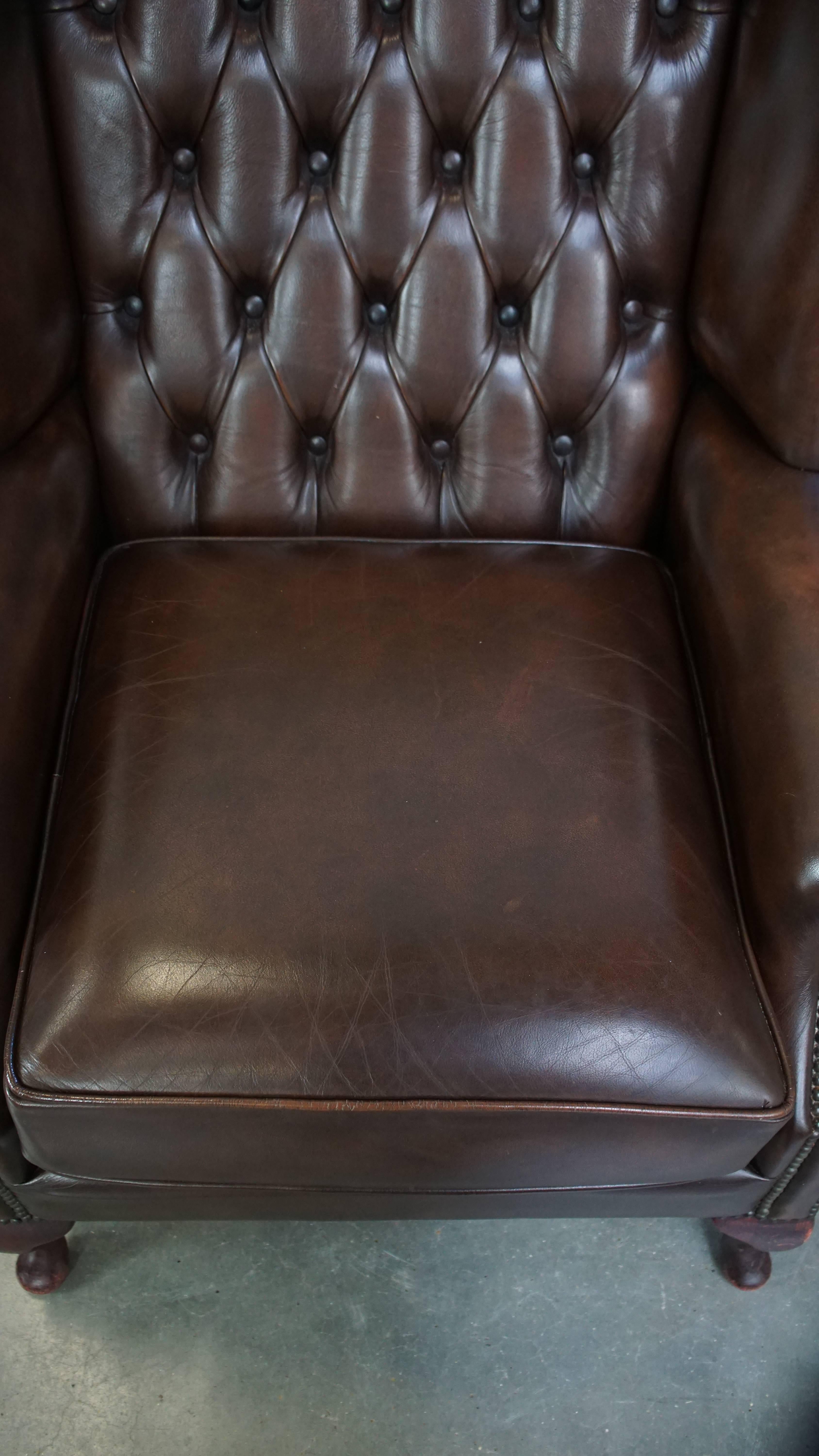Well-maintained cowhide leather chesterfield wingback chair with ...