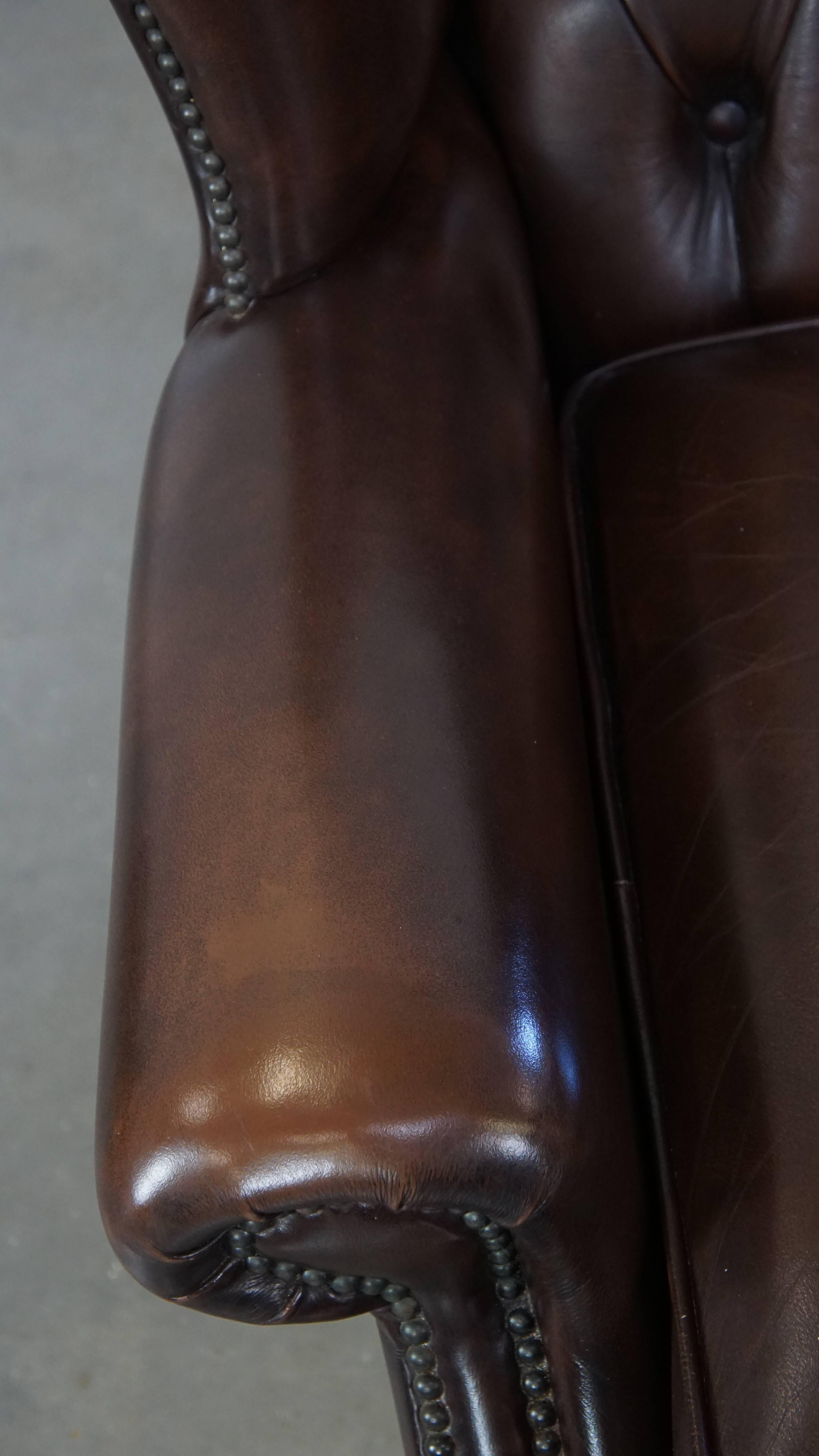 Well-maintained cowhide leather chesterfield wingback chair with ...