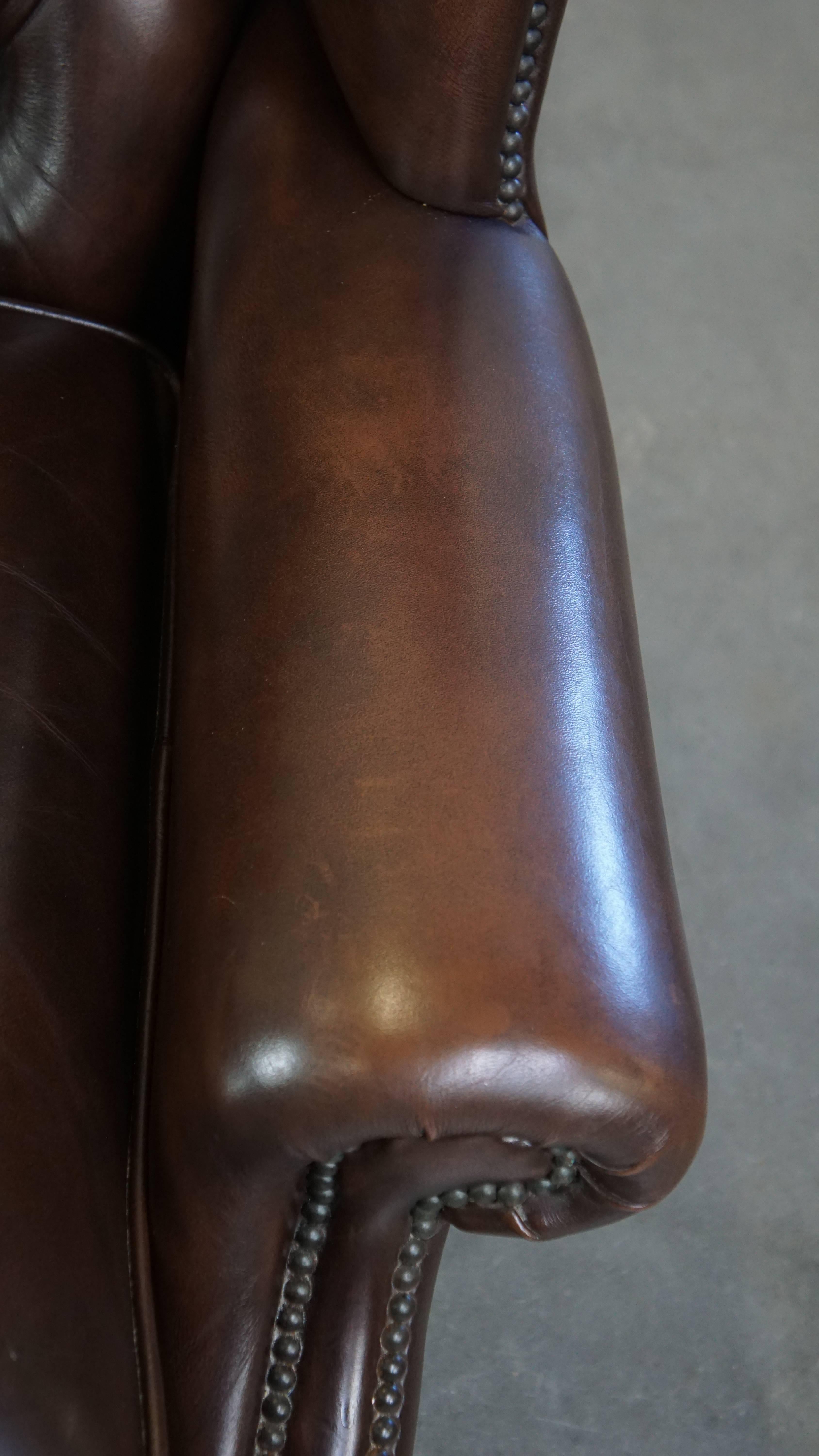 Well-maintained cowhide leather chesterfield wingback chair with ...
