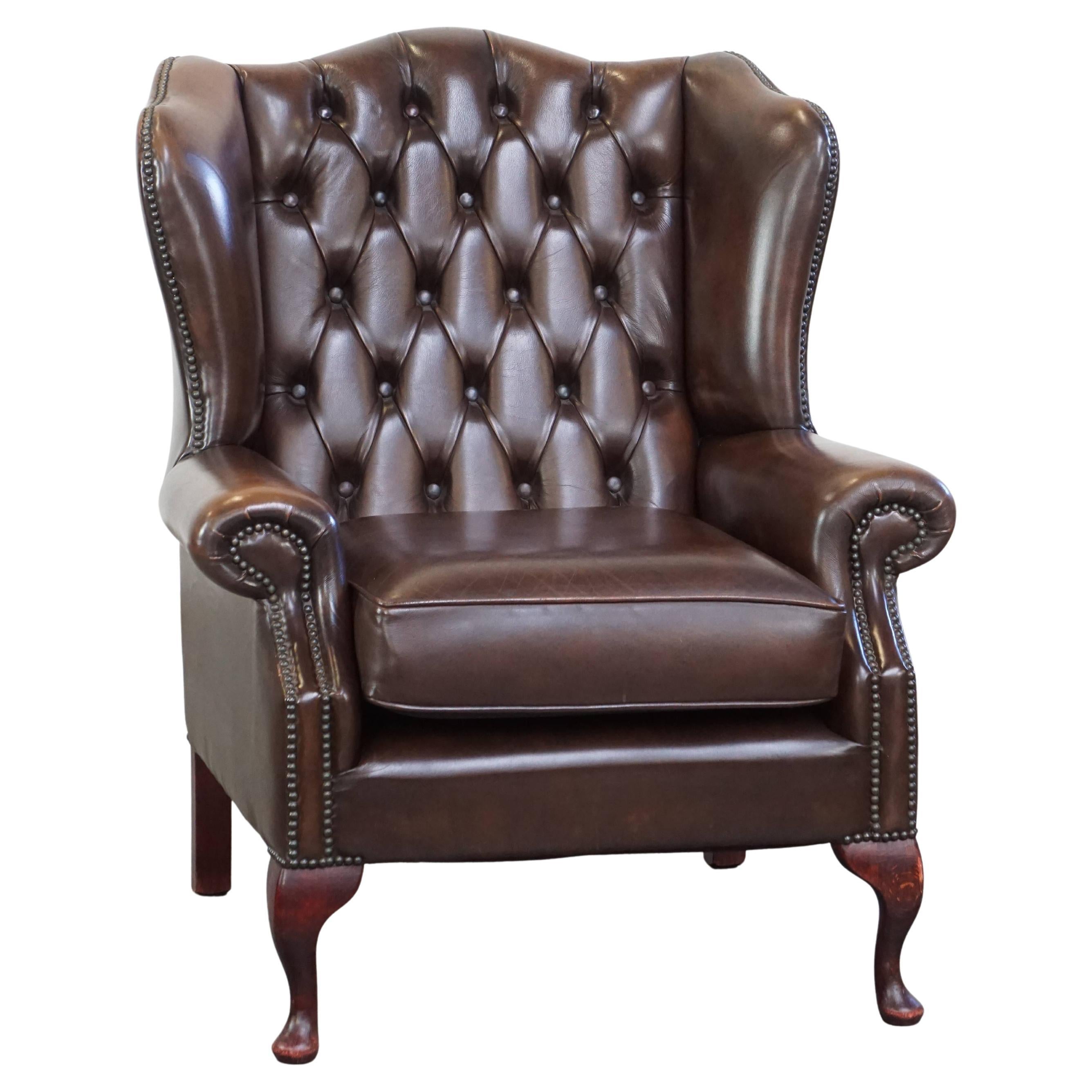 Well-maintained cowhide leather chesterfield wingback chair with ...