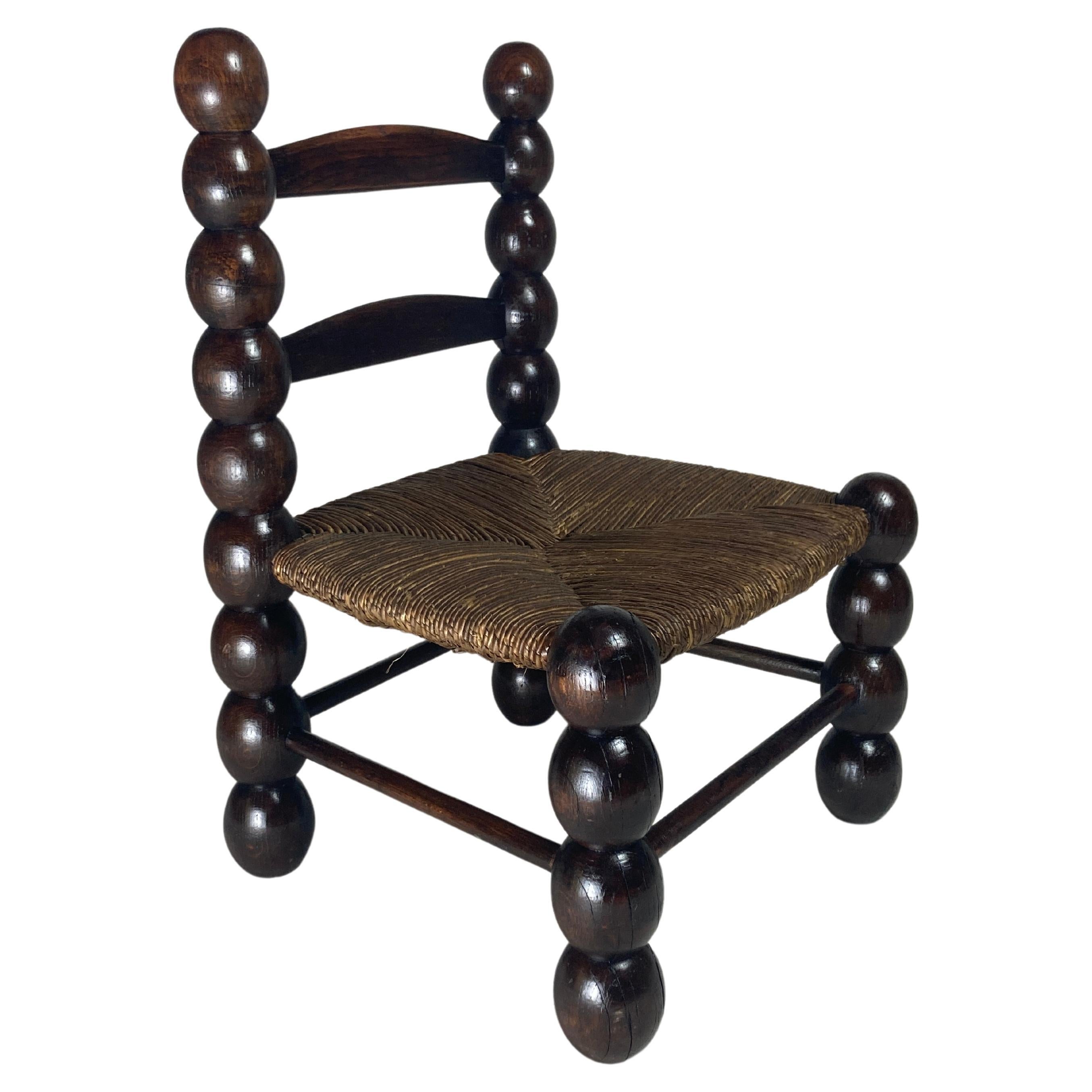Wood turned bobbin low rush chair in the style of Charles Dudouyt ...